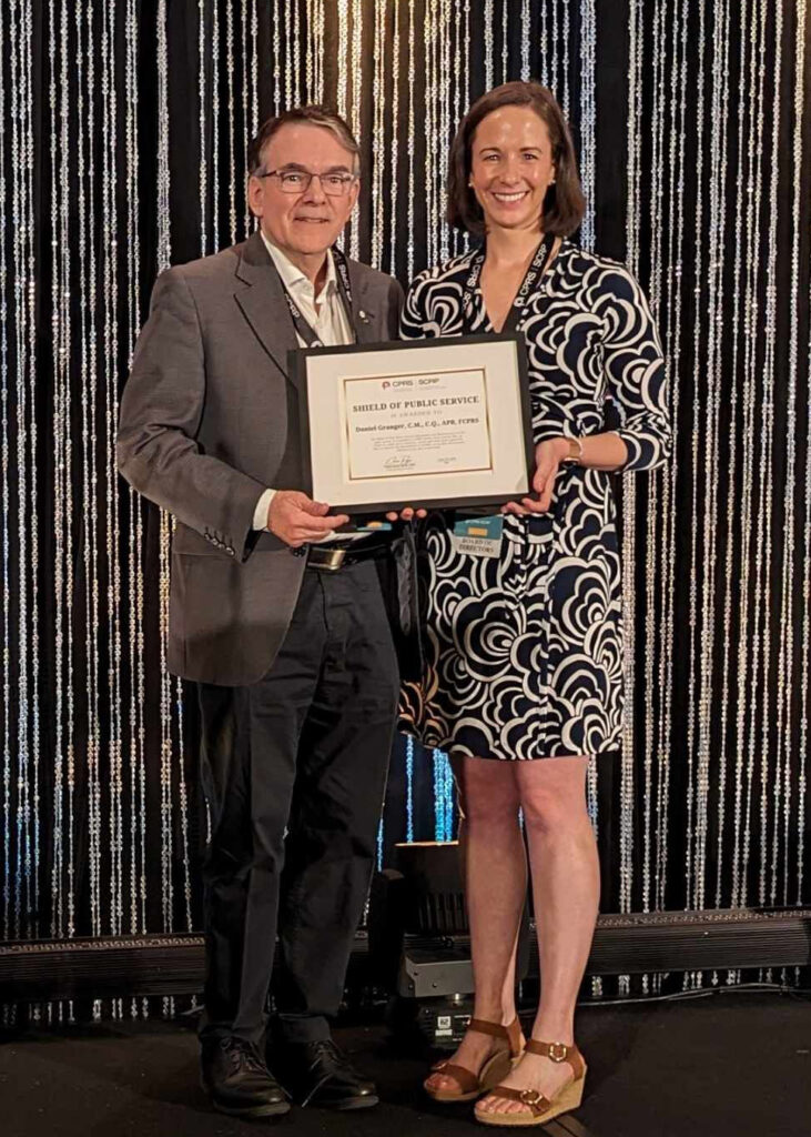 Daniel Granger receives the Shield of Public Service honours from the ...